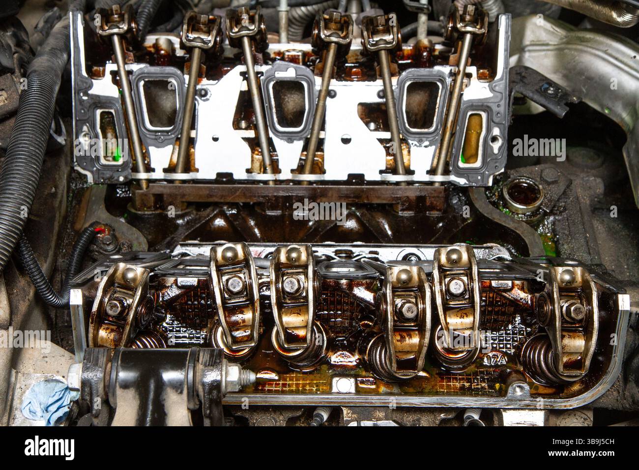 The engine of a car is open and the valves are visible. The valves are ...