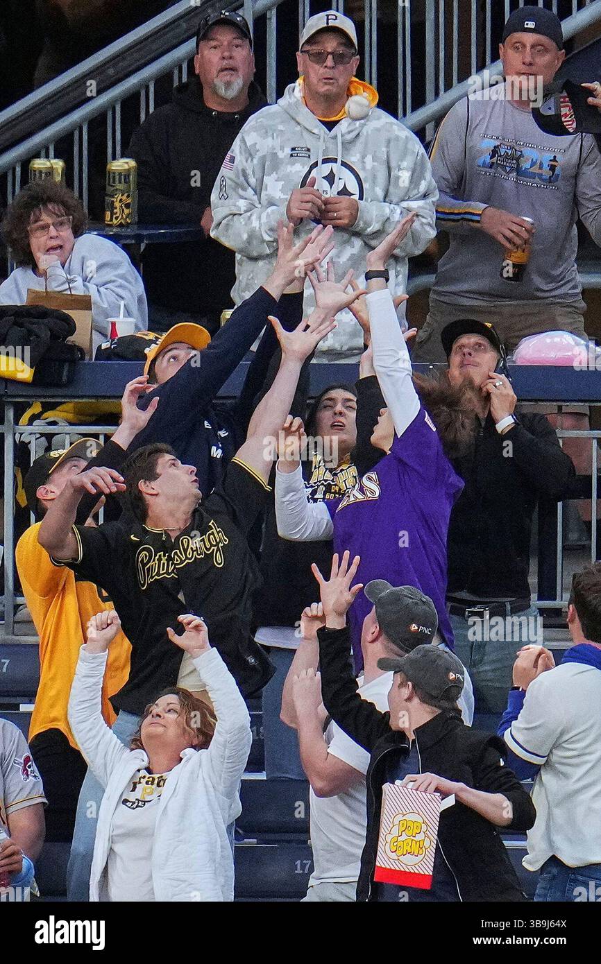 Fans reach for the ball hit by Pittsburgh Pirates' Jared Triolo for a ...