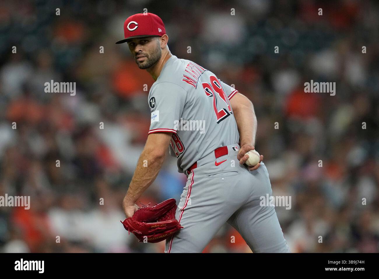 Cincinnati Reds starting pitcher Nick Martinez (28) looks back at first ...