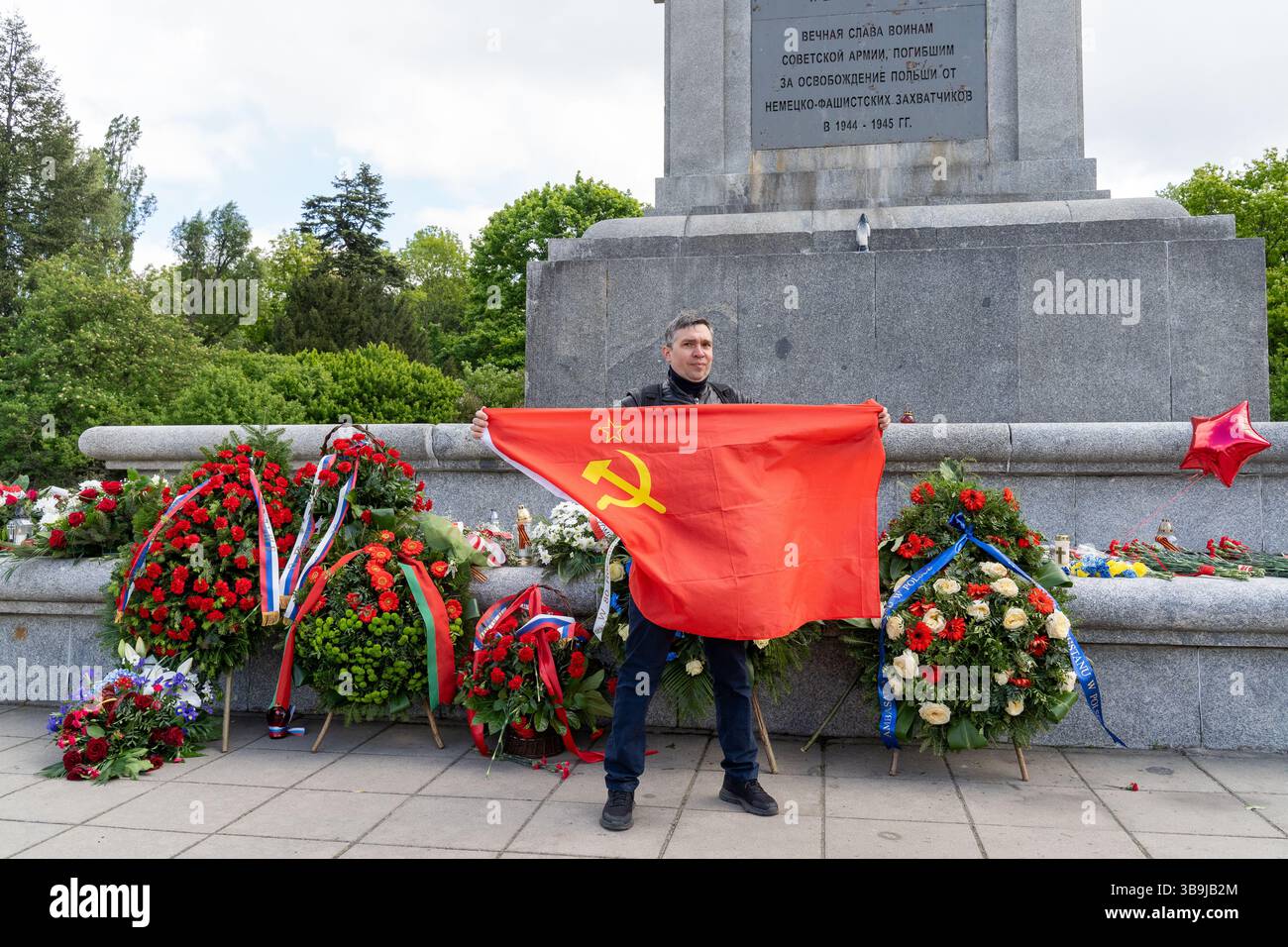 A protester waves a Soviet Union flag during the 80th anniversary of ...