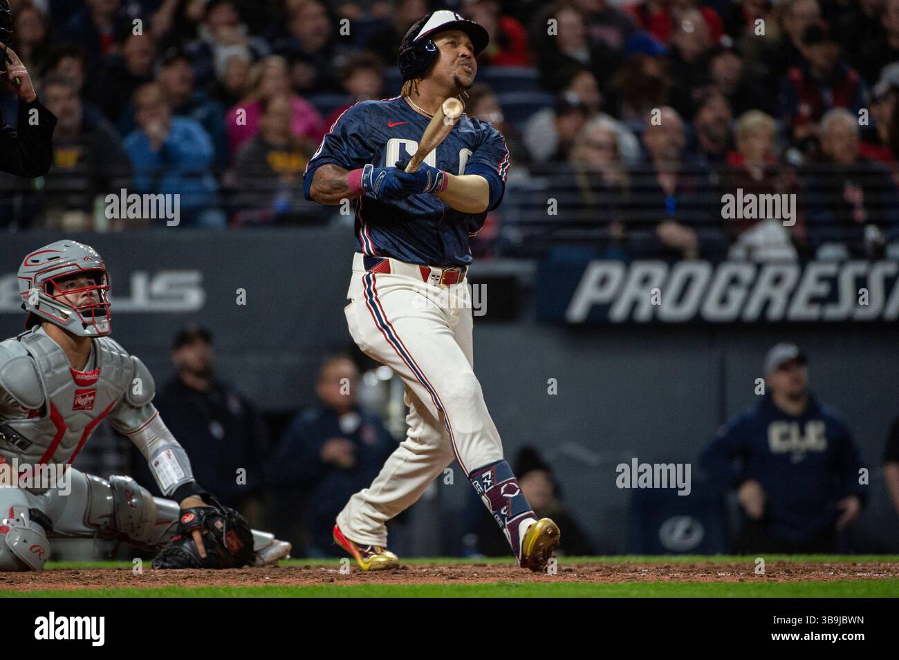 Cleveland Guardians' Jose Ramirez, right, watches his solo home run off ...