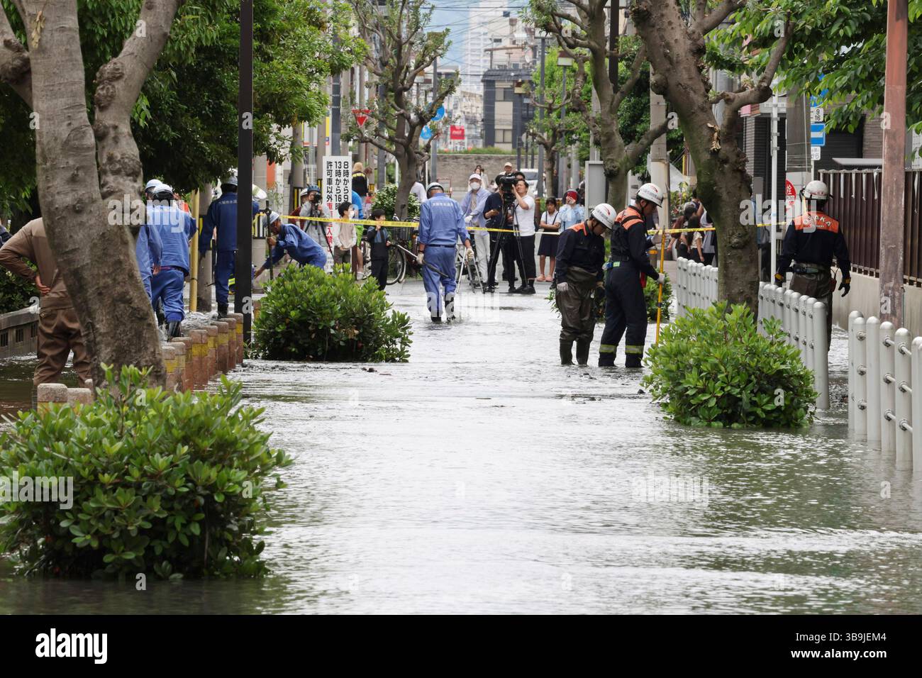 A photo shows a flooded road after a water pipe burst, in Joto Ward ...