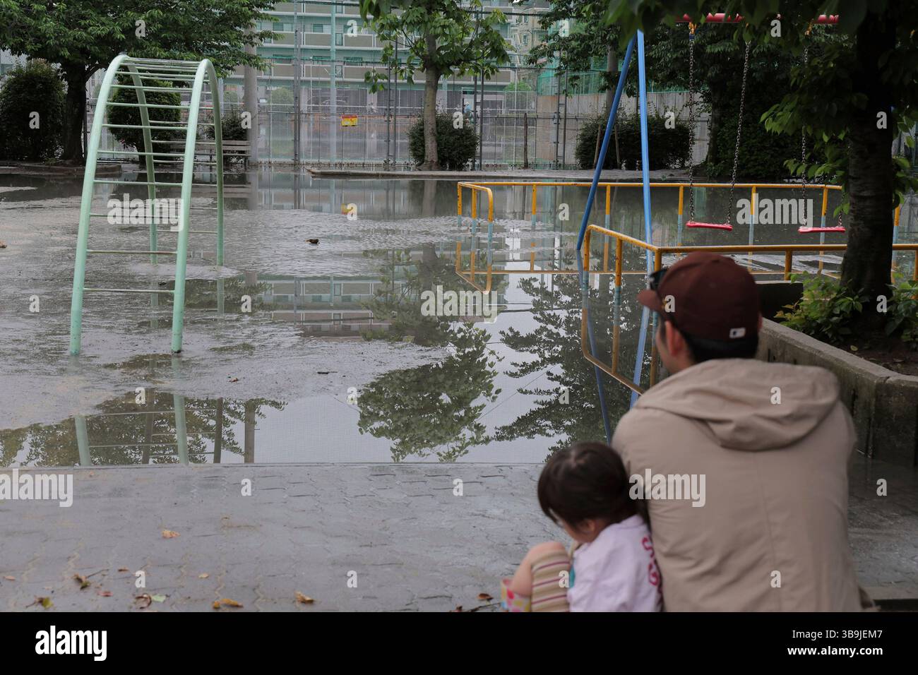 A photo shows a flooded park after a water pipe burst, in Joto Ward ...