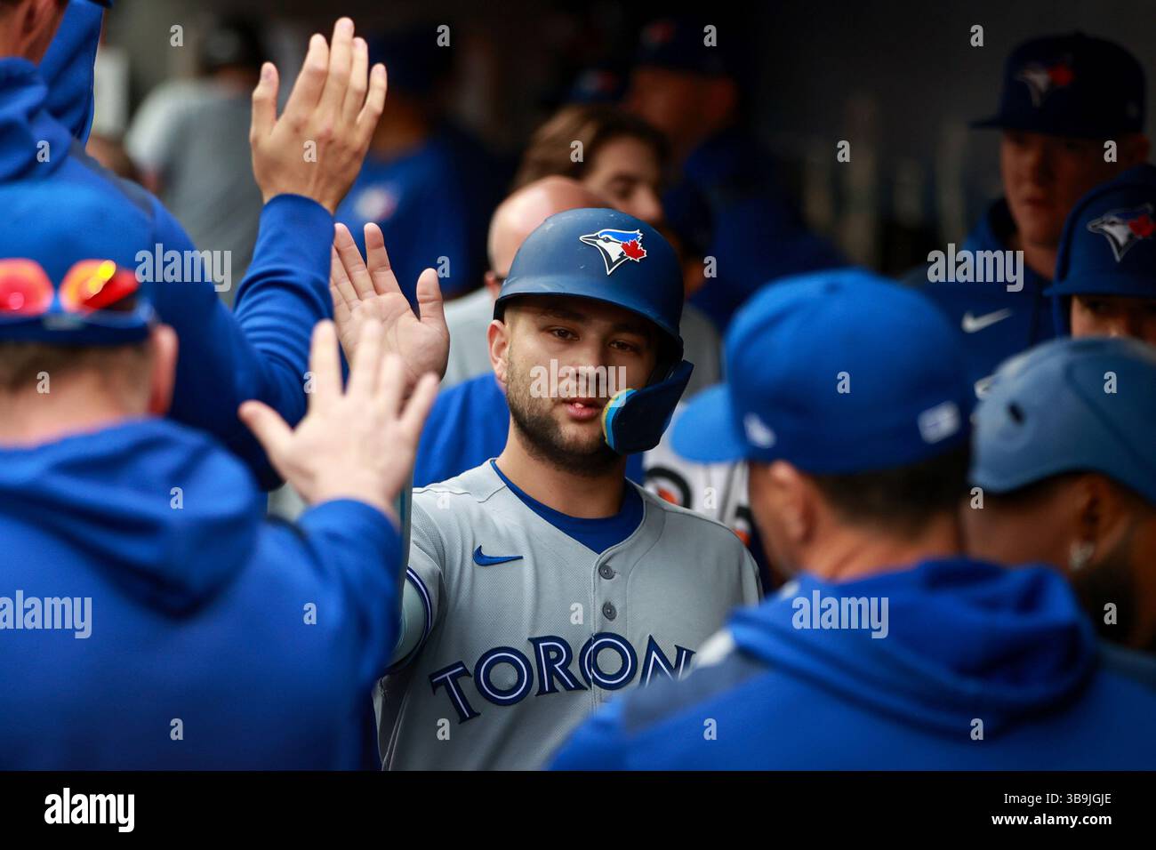 Toronto Blue Jays' Bo Bichette, center, is greeted in the dugout after ...
