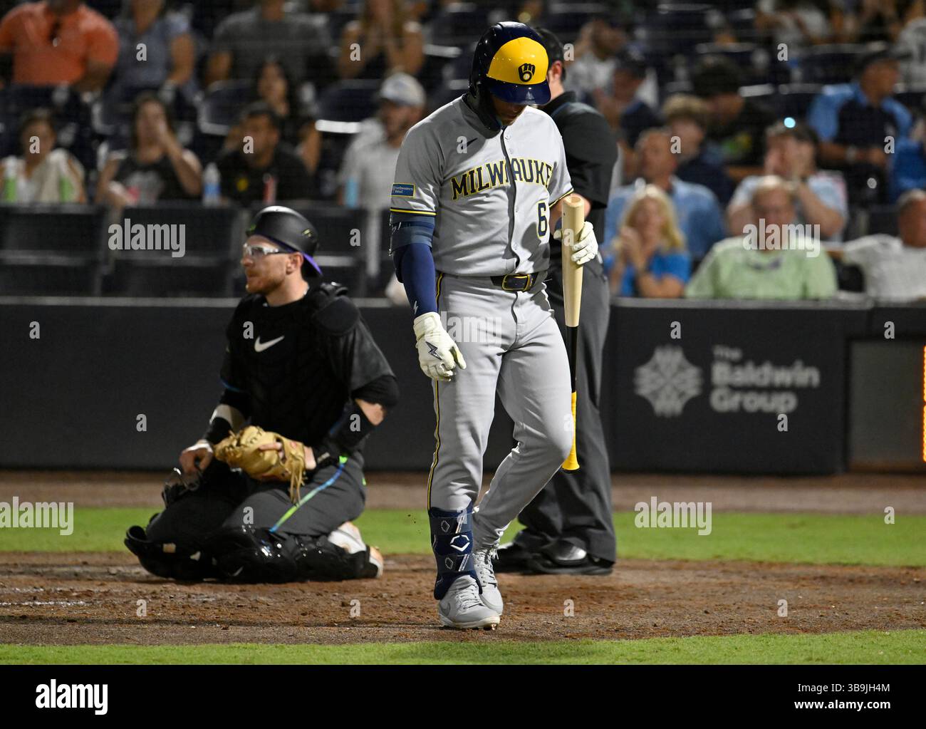 Milwaukee Brewers' Isaac Collins (6) walks to the dugout after striking ...