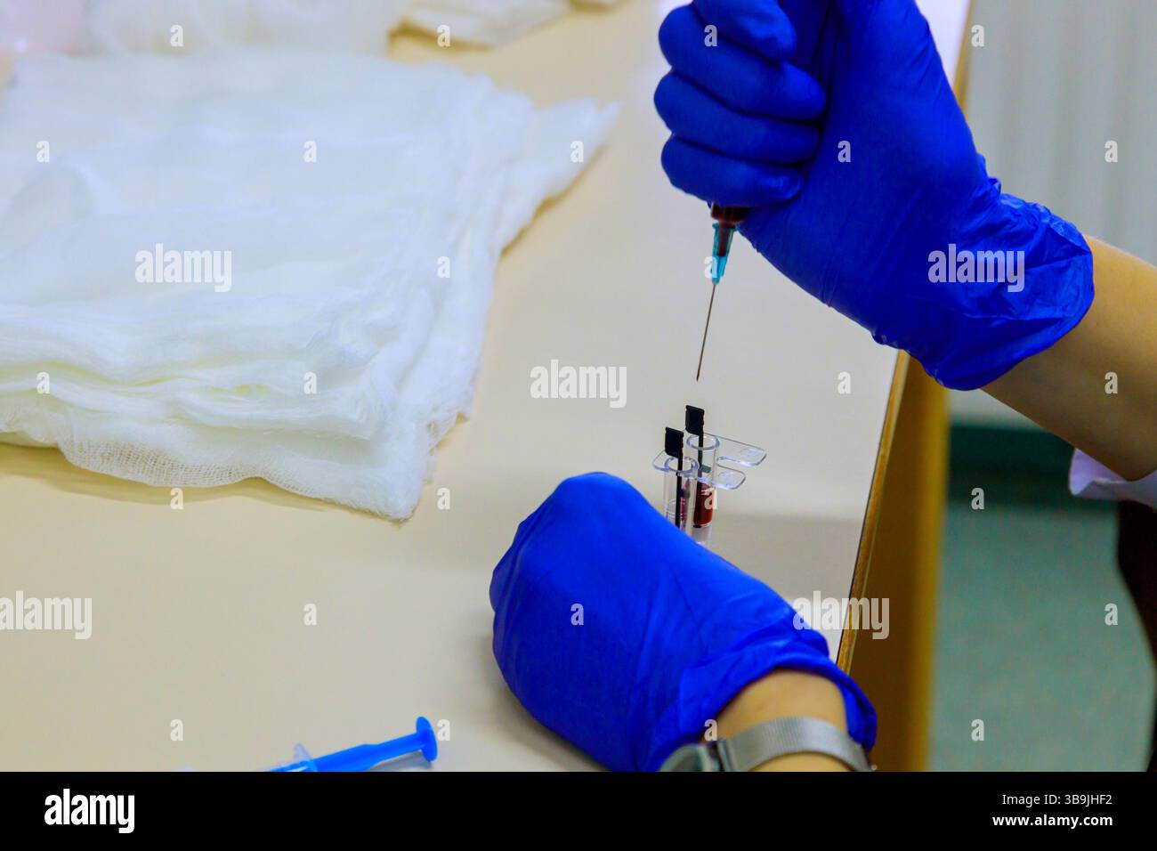 Healthcare worker in gloves prepares for blood sample collection in sterile clinical laboratory ...
