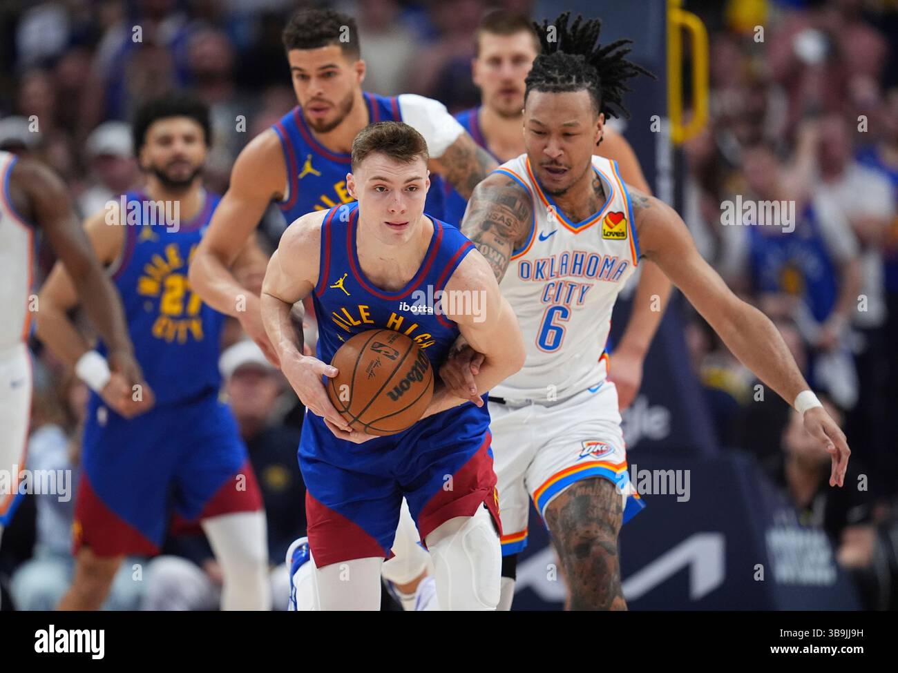 Denver Nuggets guard Christian Braun, front left, collects the ball as ...