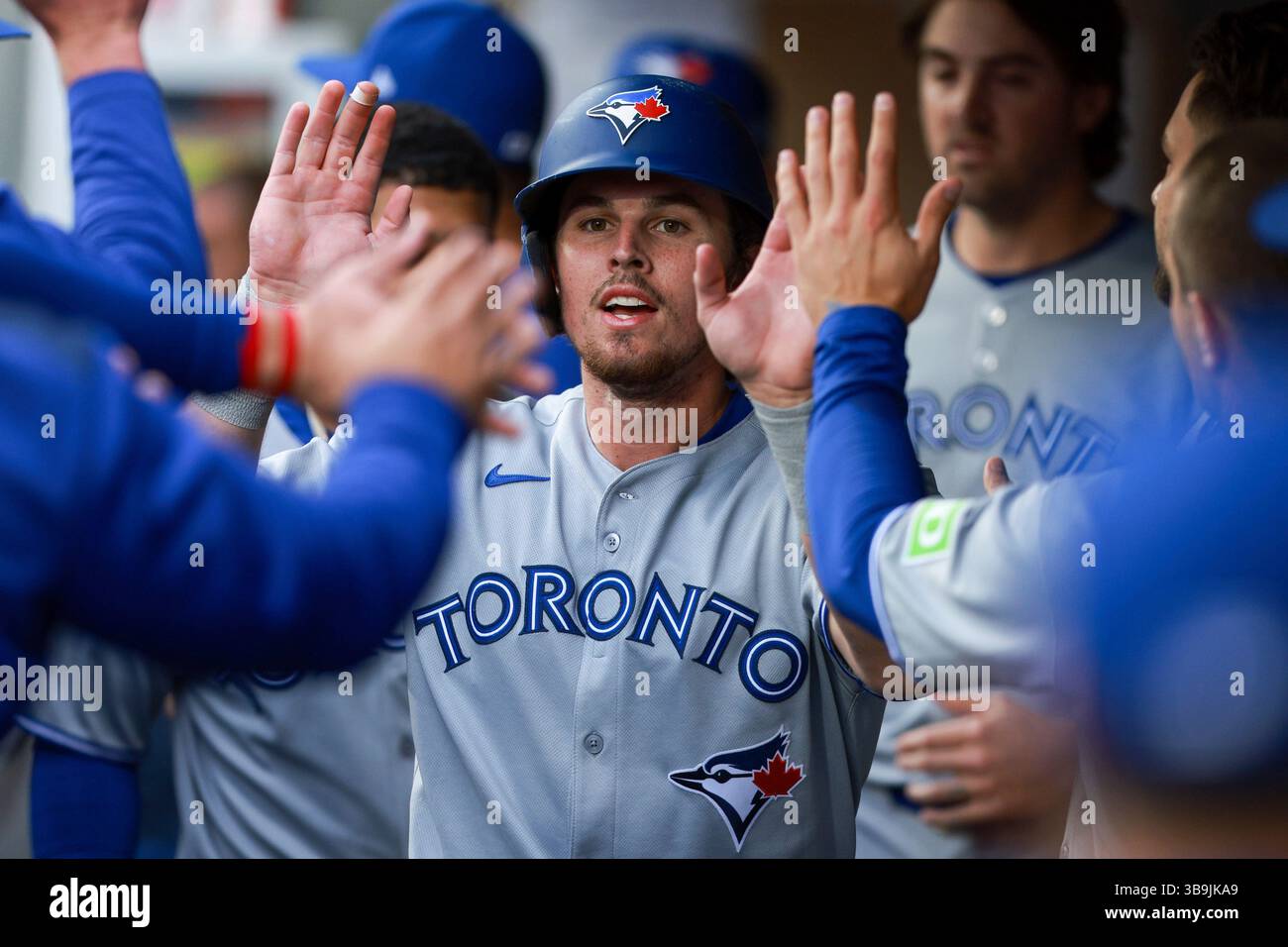 Toronto Blue Jays' Addison Barger, center, is greeted in the dugout ...