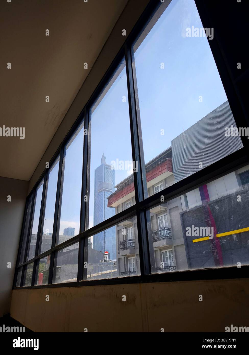 Framing of a skyscraper through the windows of a building Stock Photo ...