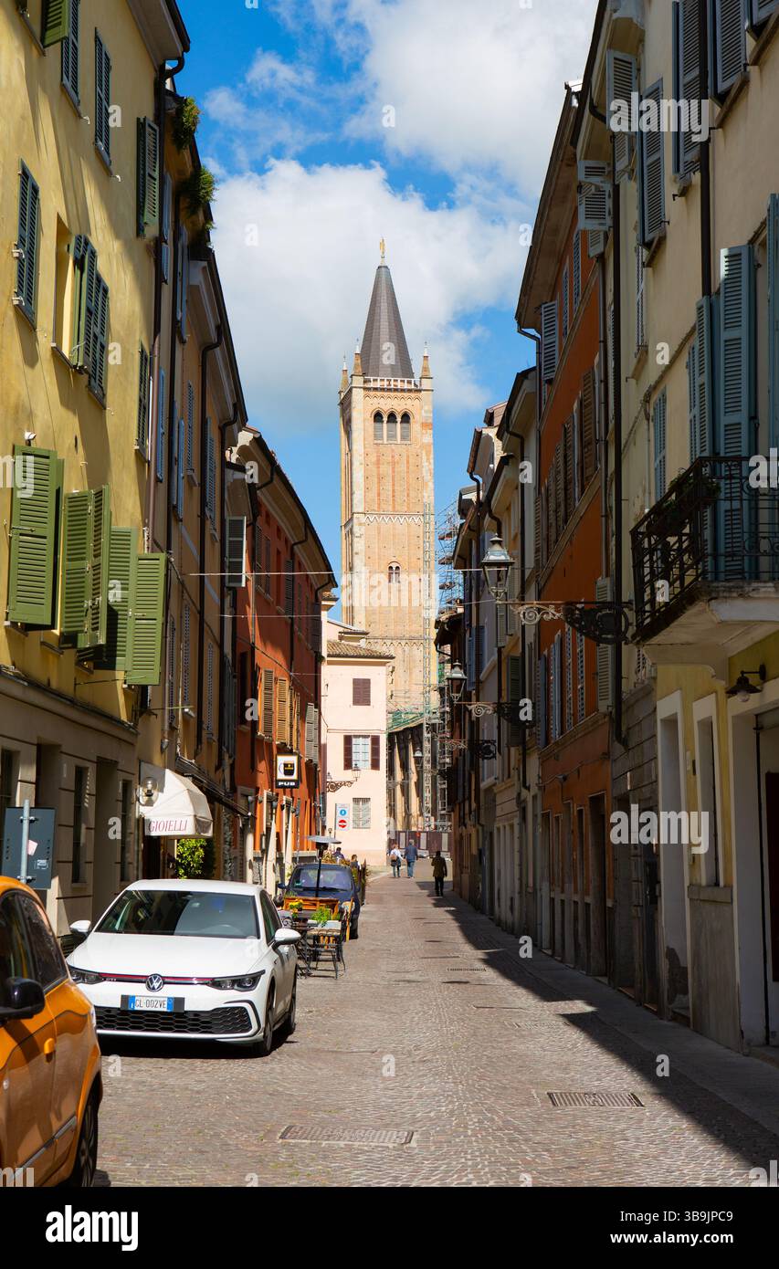 Italian street scene historic tower people walking colorful buildings ...
