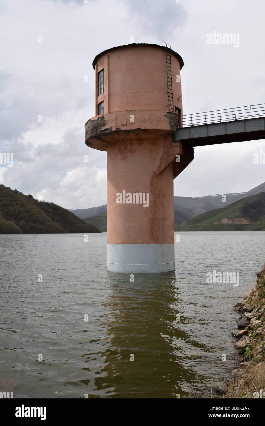 Reservoir and dam. Lighthouse in the reservoir. Lake in the mountains ...