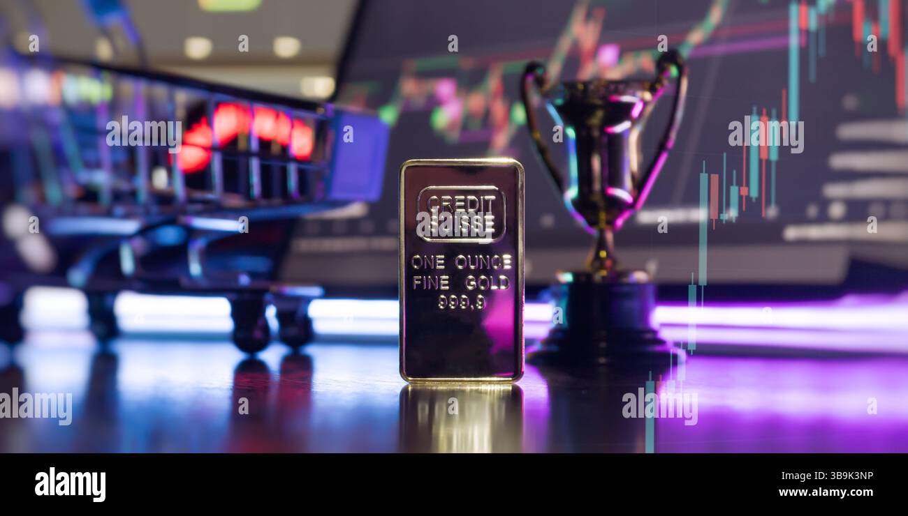 Gold bullion bar in front of stock chart and trophy, symbolizing ...