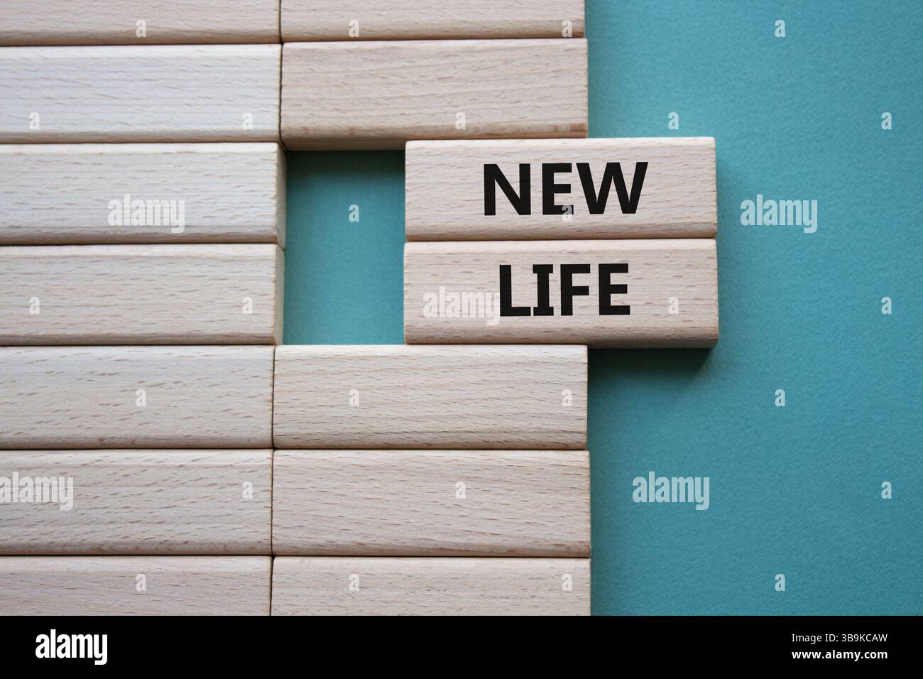 New life symbol. Wooden blocks with words New life. Beautiful grey ...