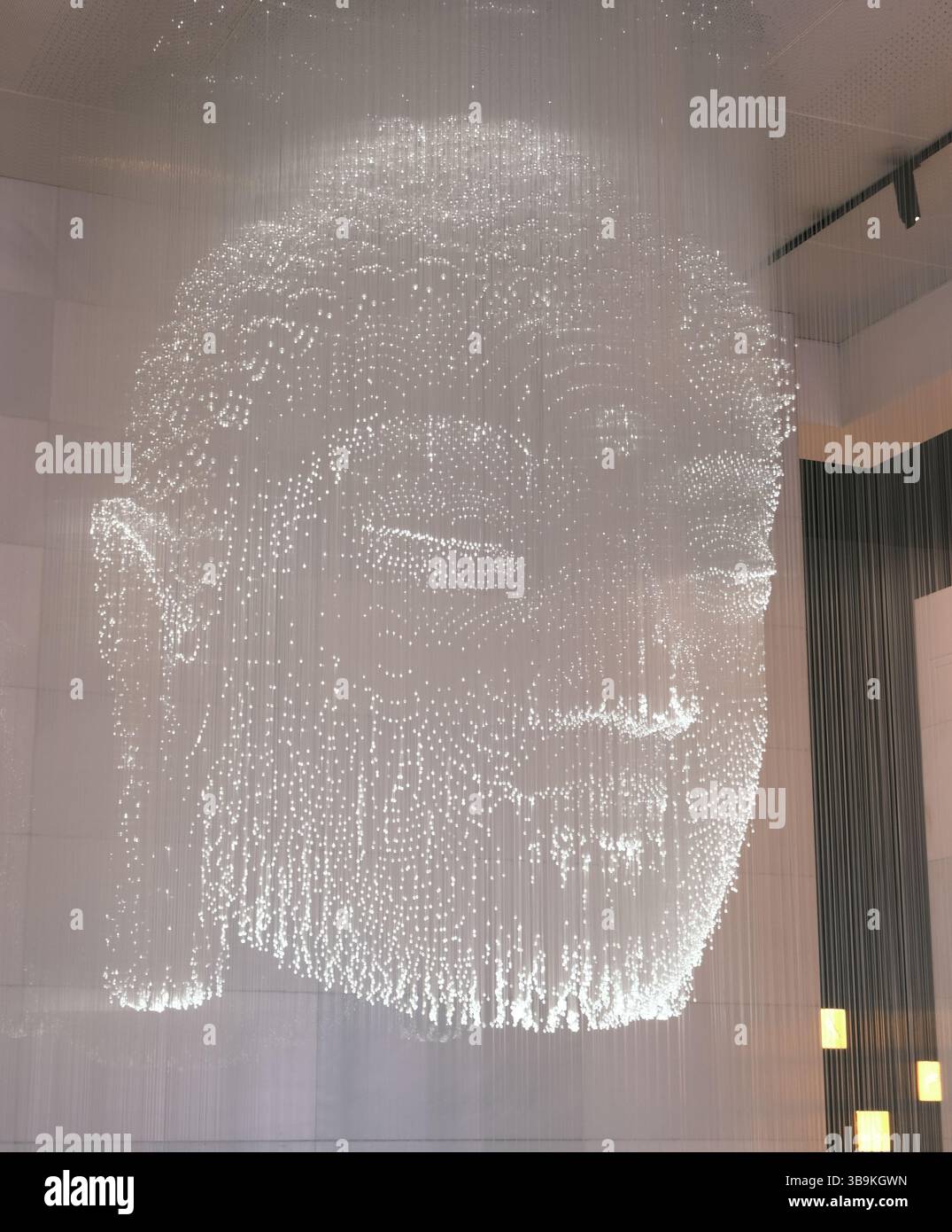 Illuminated Buddha head installation made of light tubes inside the ...