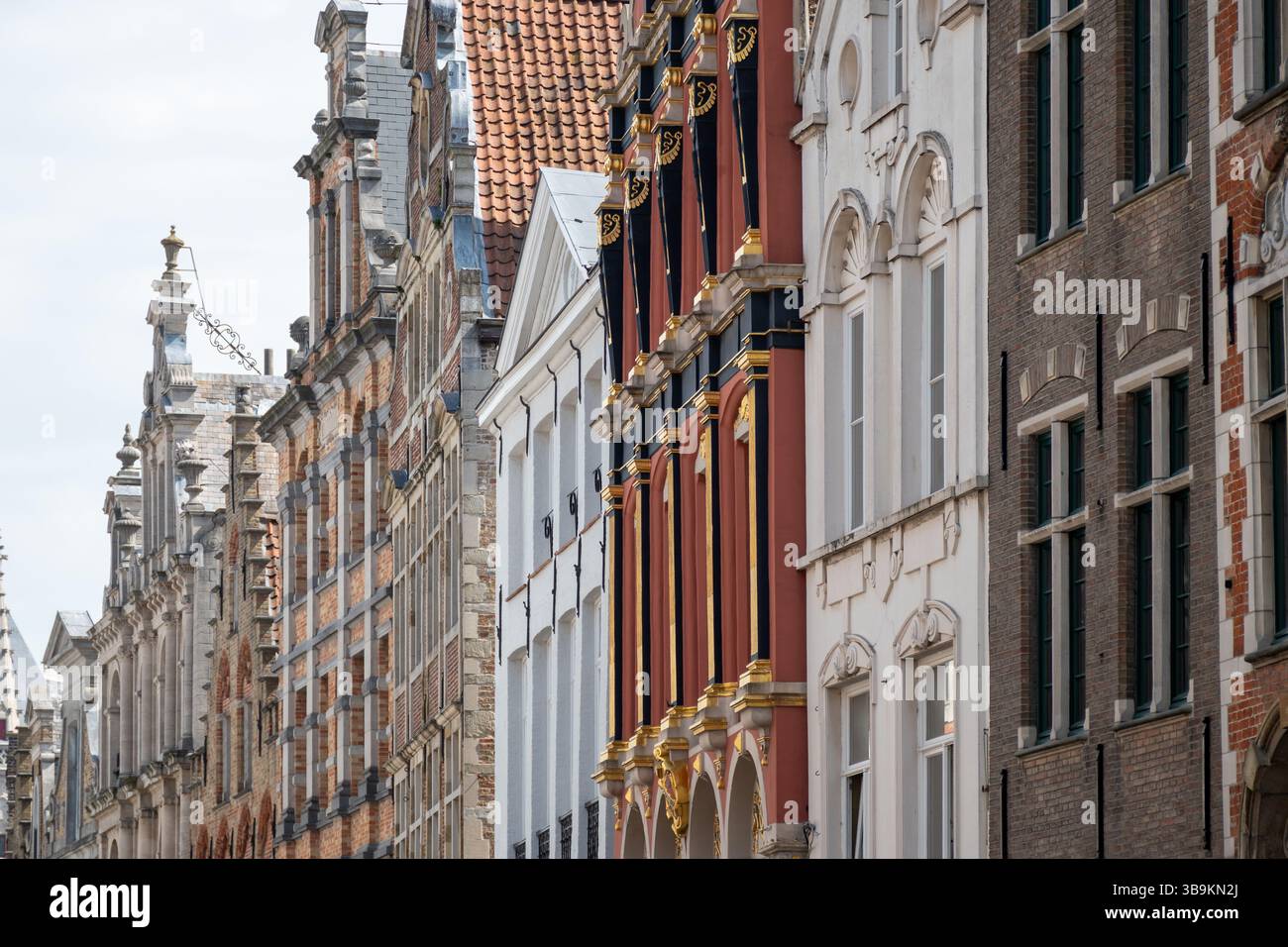 Medieval houses facades and rooftops and city tower with bells in the ...