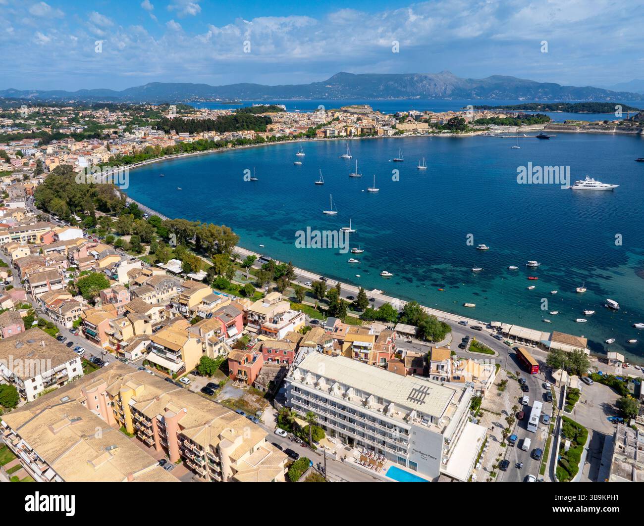Aerial view of Corfu Island showcasing coastal town, blue bay with ...
