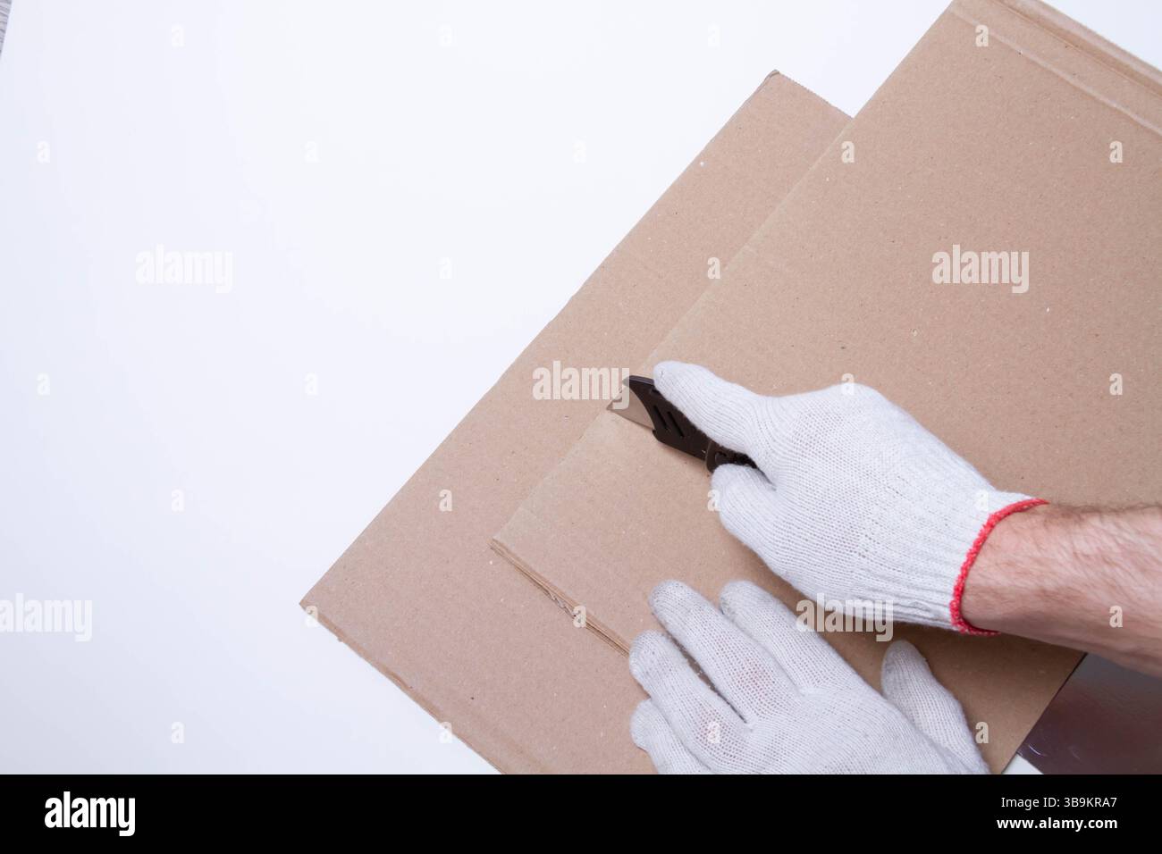 Packing the goods in a cardboard box and stretch film. Tools for ...