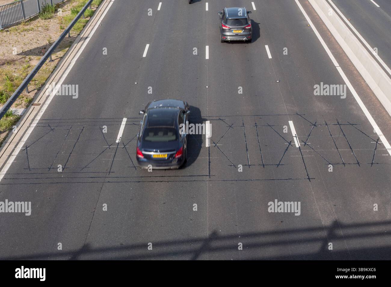 Traffic passing over vehicle detection loops, M4 motorway, Dorney, UK ...
