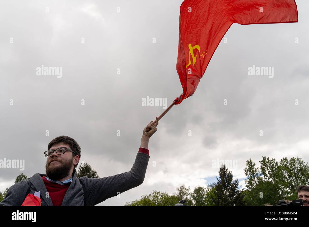 A man waves a Soviet Union flag as he takes part in the 80th ...