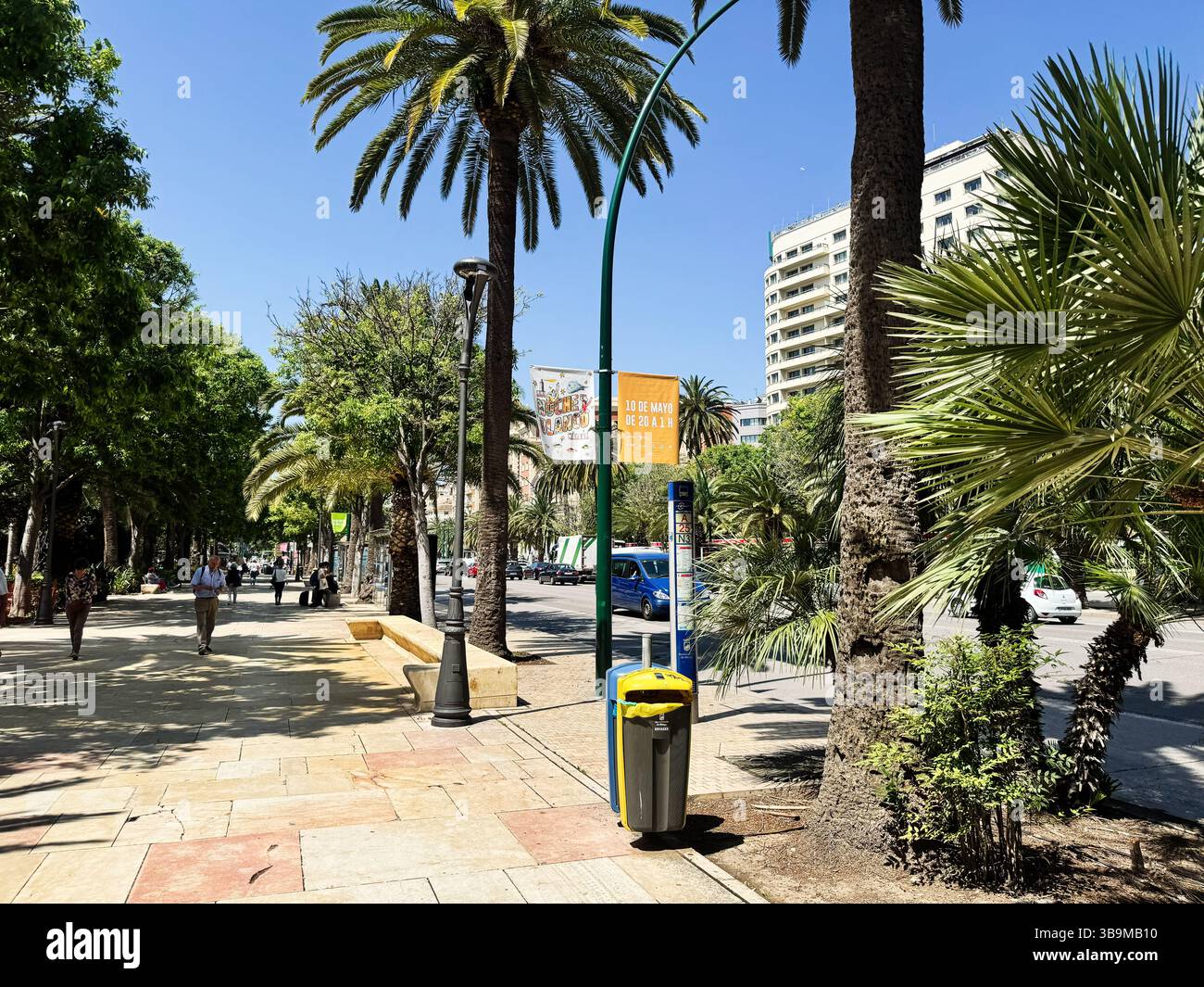 Malaga, Spain - May 02, 2025: Sunny park promenade with palm trees ...