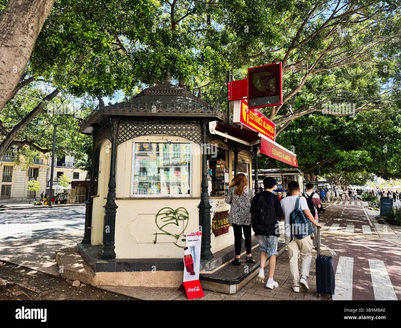 Malaga, Spain - May 02, 2025: Street kiosk in Malaga surrounded by lush ...