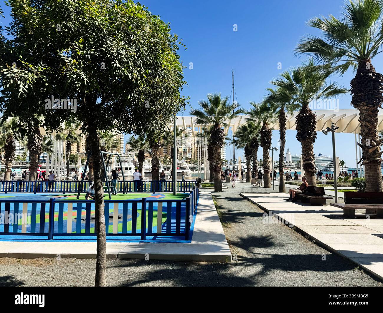 Malaga, Spain - May 02, 2025: Sunny day at Malaga harbor with palm ...
