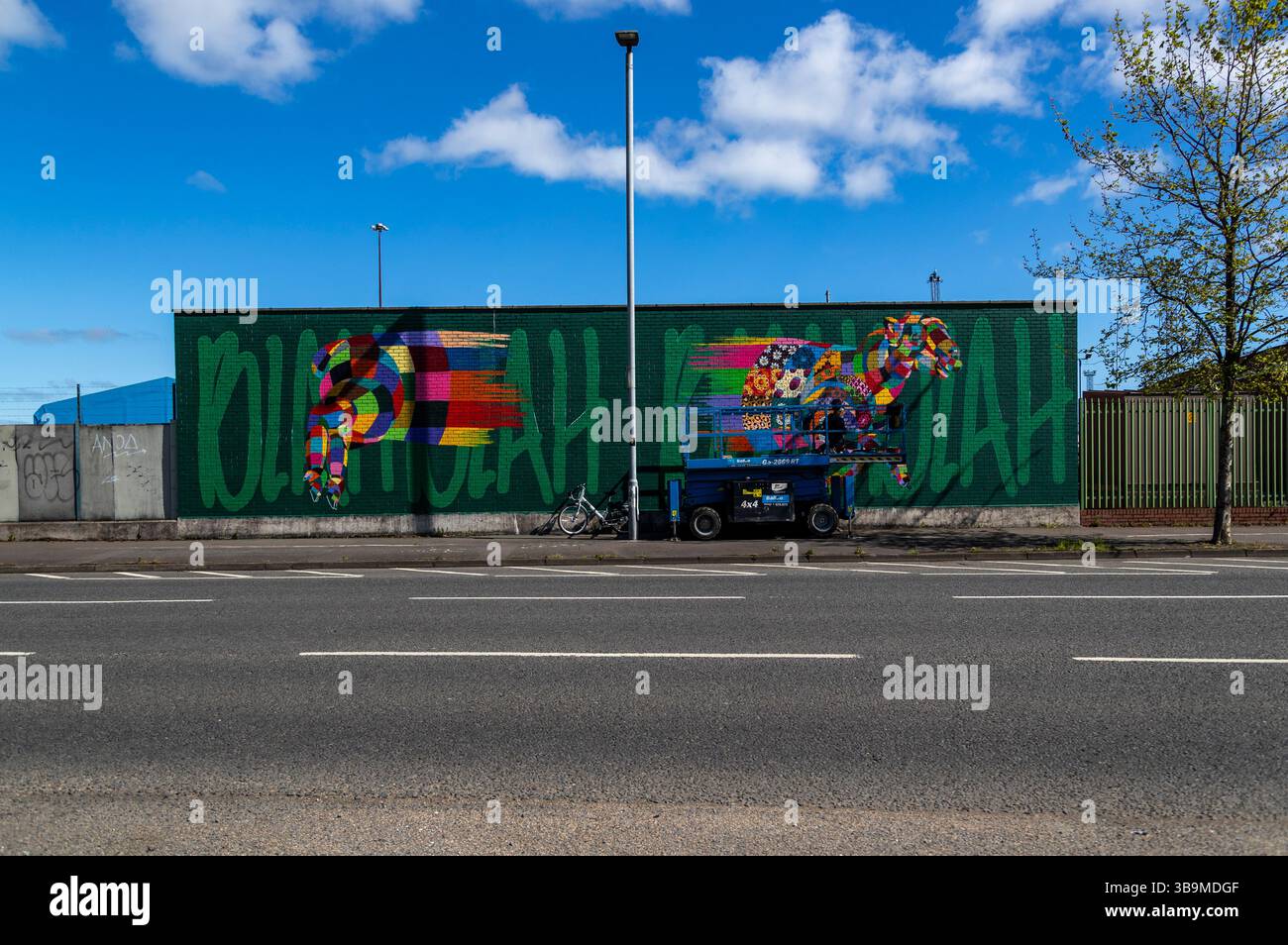 Artist Louis Masai working on a mural for Hit the North Translink ...