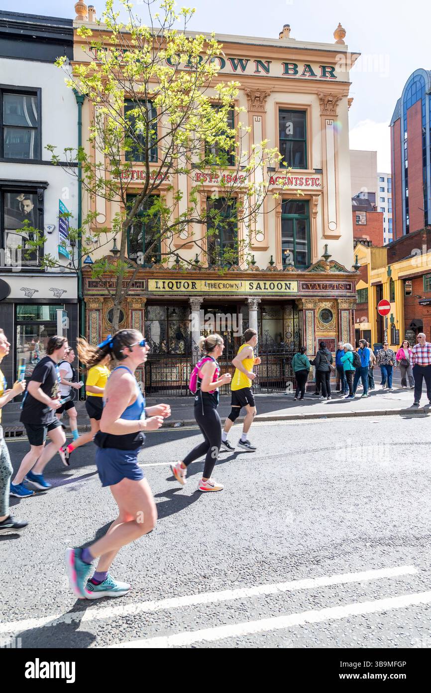 Runners in the Belfast Marathon jog past the famous Crown Bar, Belfast ...