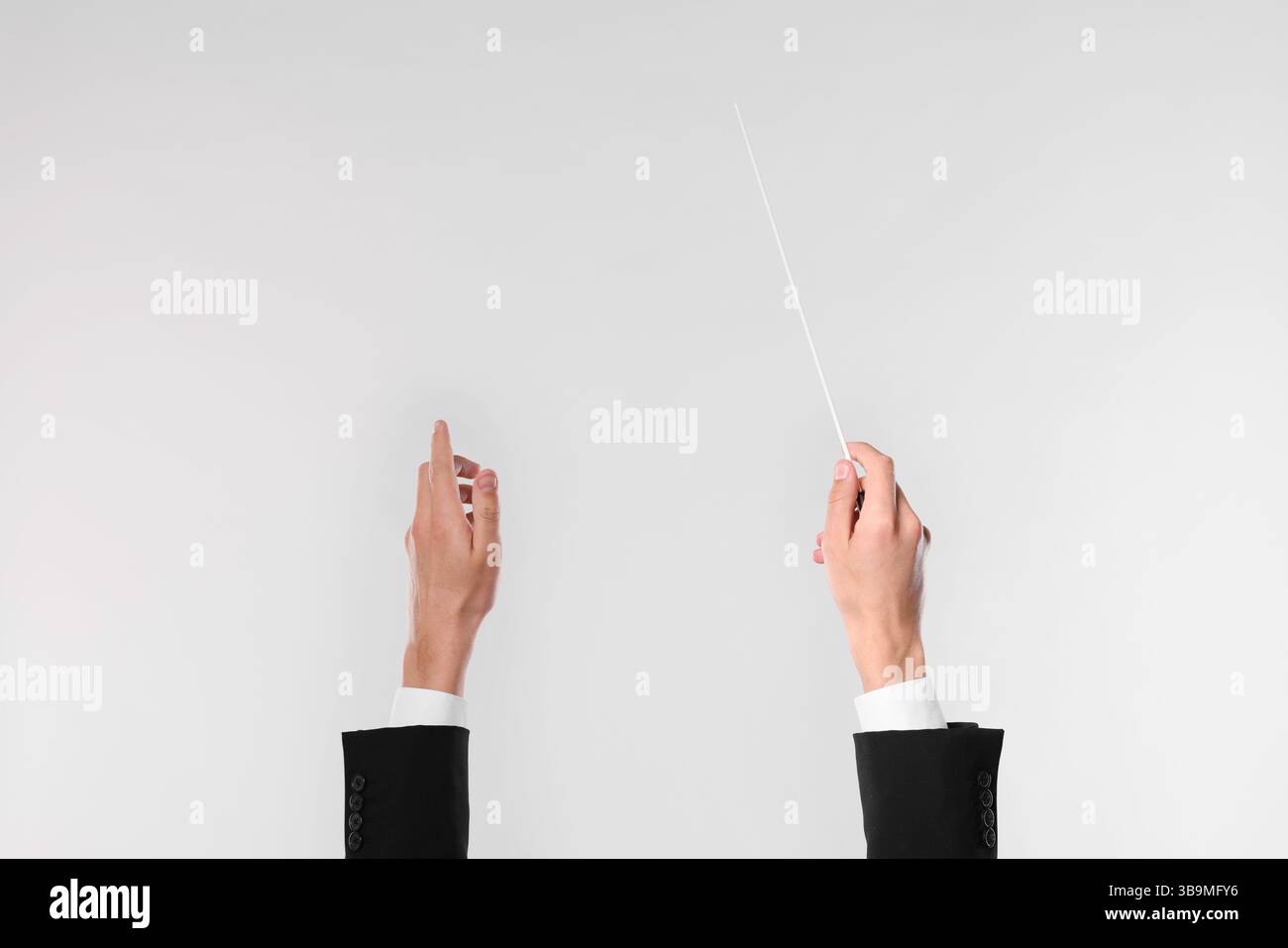 Conductor with baton on light grey background, closeup Stock Photo - Alamy