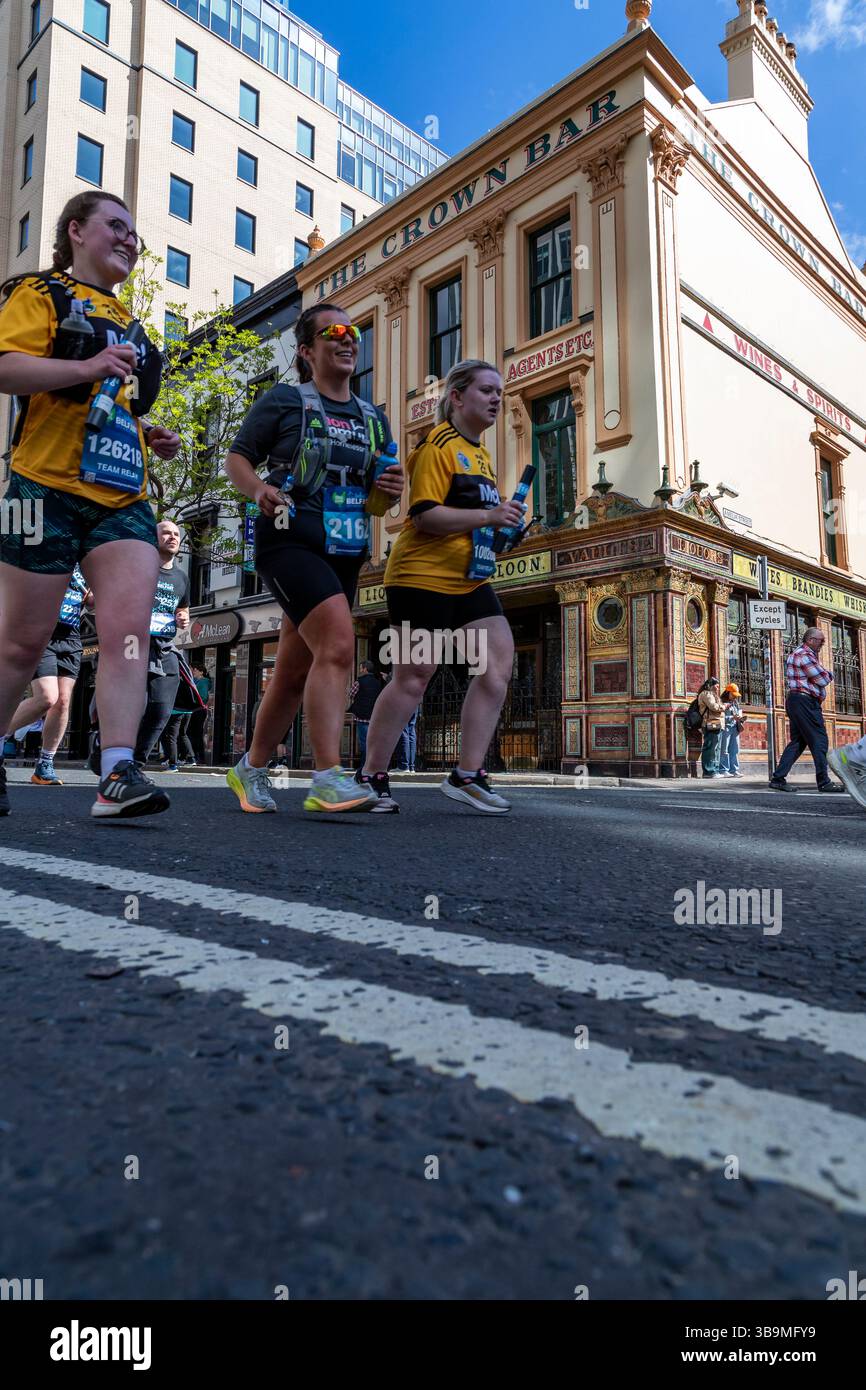 Runners in the Belfast Marathon jog past the famous Crown Bar, Belfast ...