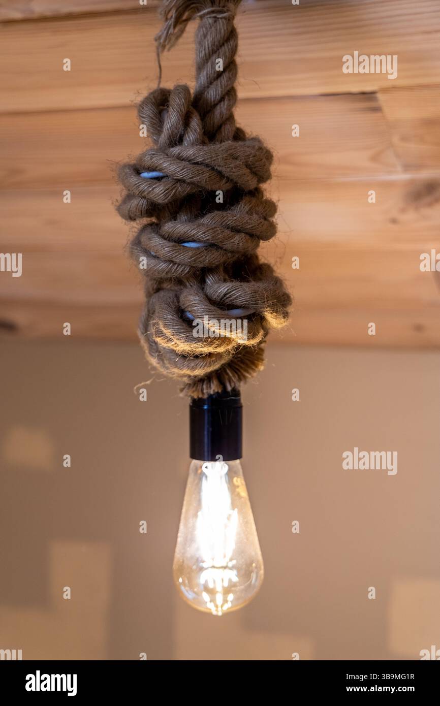 Yellow light bulb The sphere hanging with a rope Stock Photo - Alamy