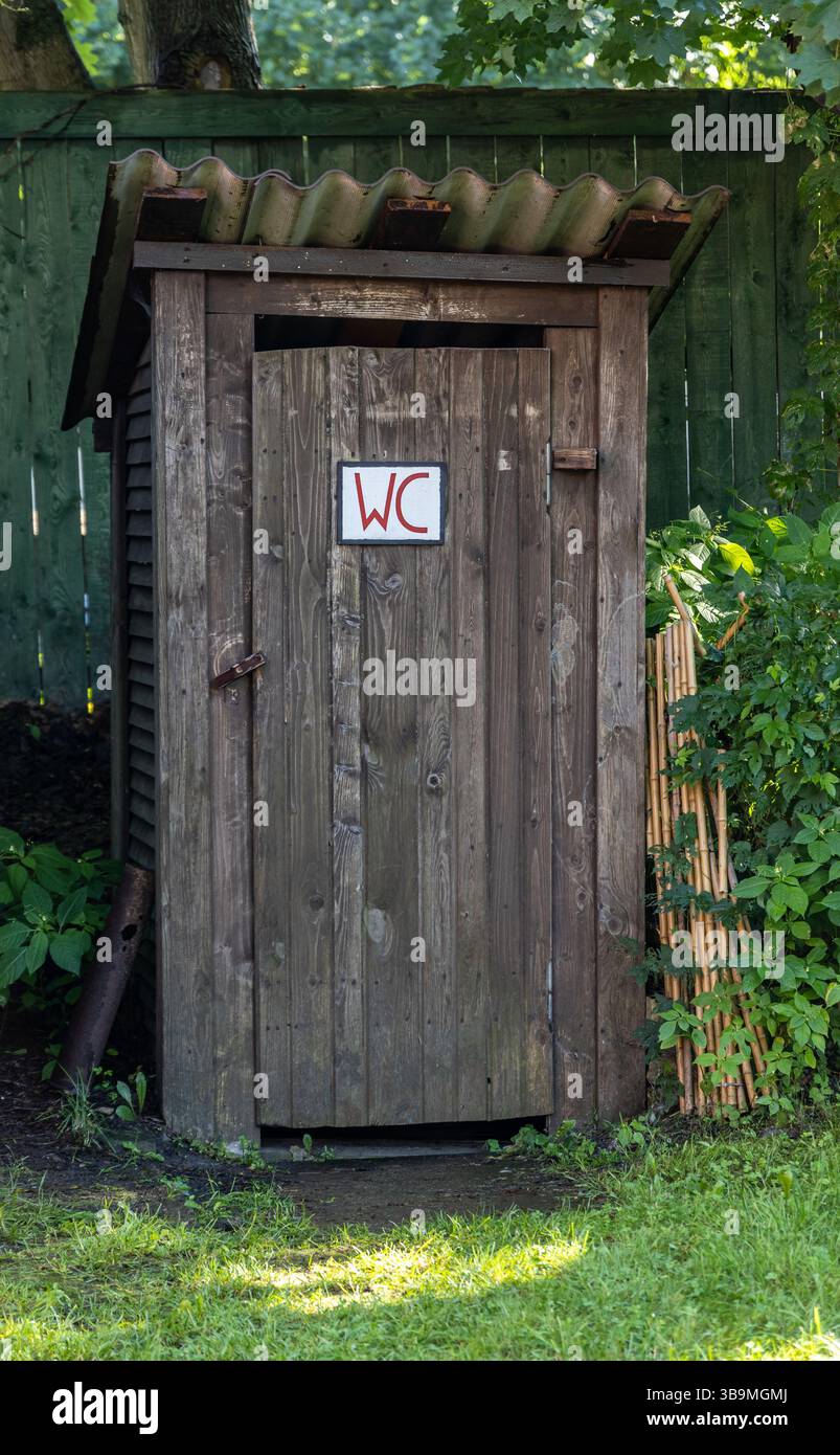 Wooden toilet in the forest. Blue colored natural bio WC cabin among ...