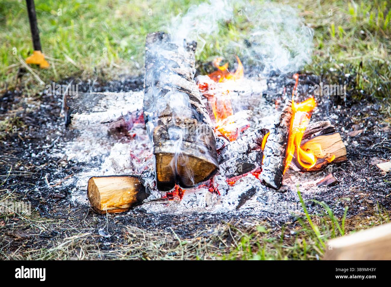 Burning fire logs of wood close-up outdoors. The hot embers of burning ...