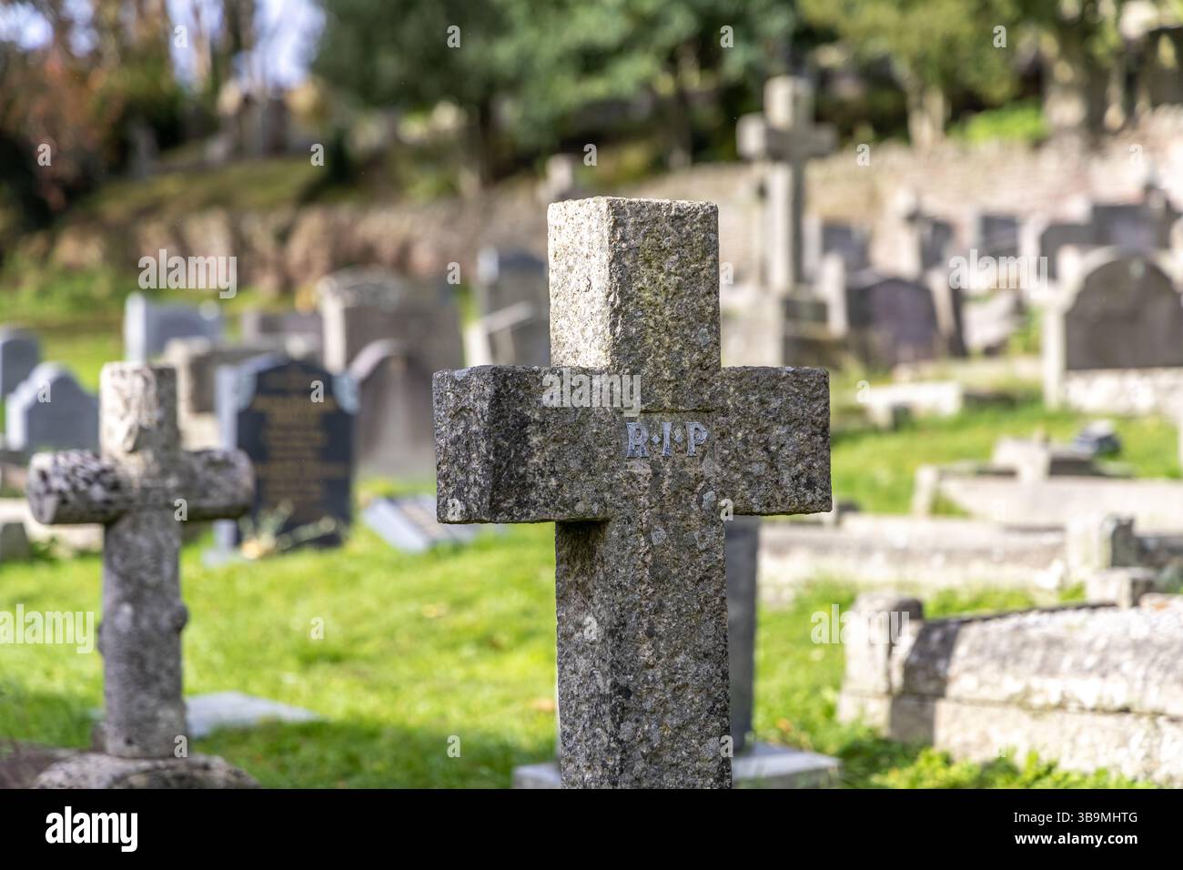 RIP on Cross Grave Stone with cemetery behind Stock Photo - Alamy