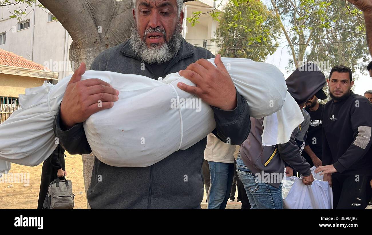 Palestinians mourn the loss of their loved ones killed in an Israeli ...