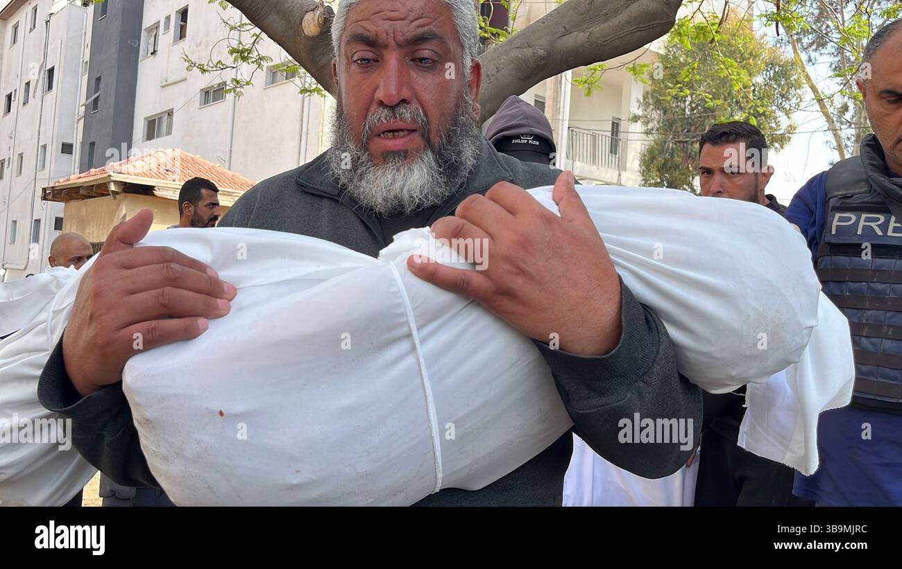 Palestinians mourn the loss of their loved ones killed in an Israeli ...