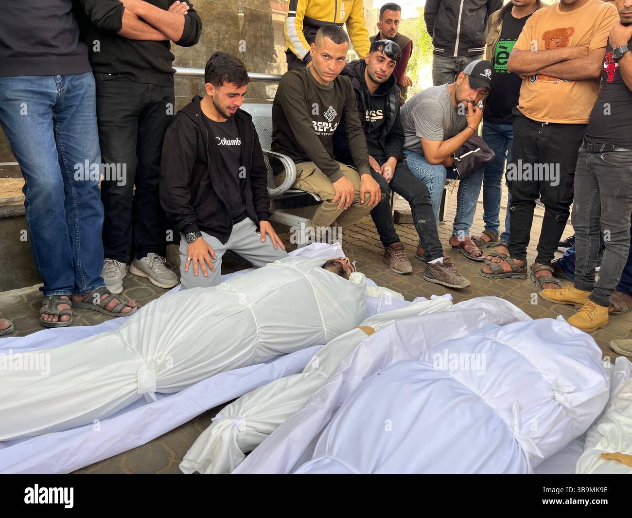 Palestinians mourn the loss of their loved ones killed in an Israeli ...