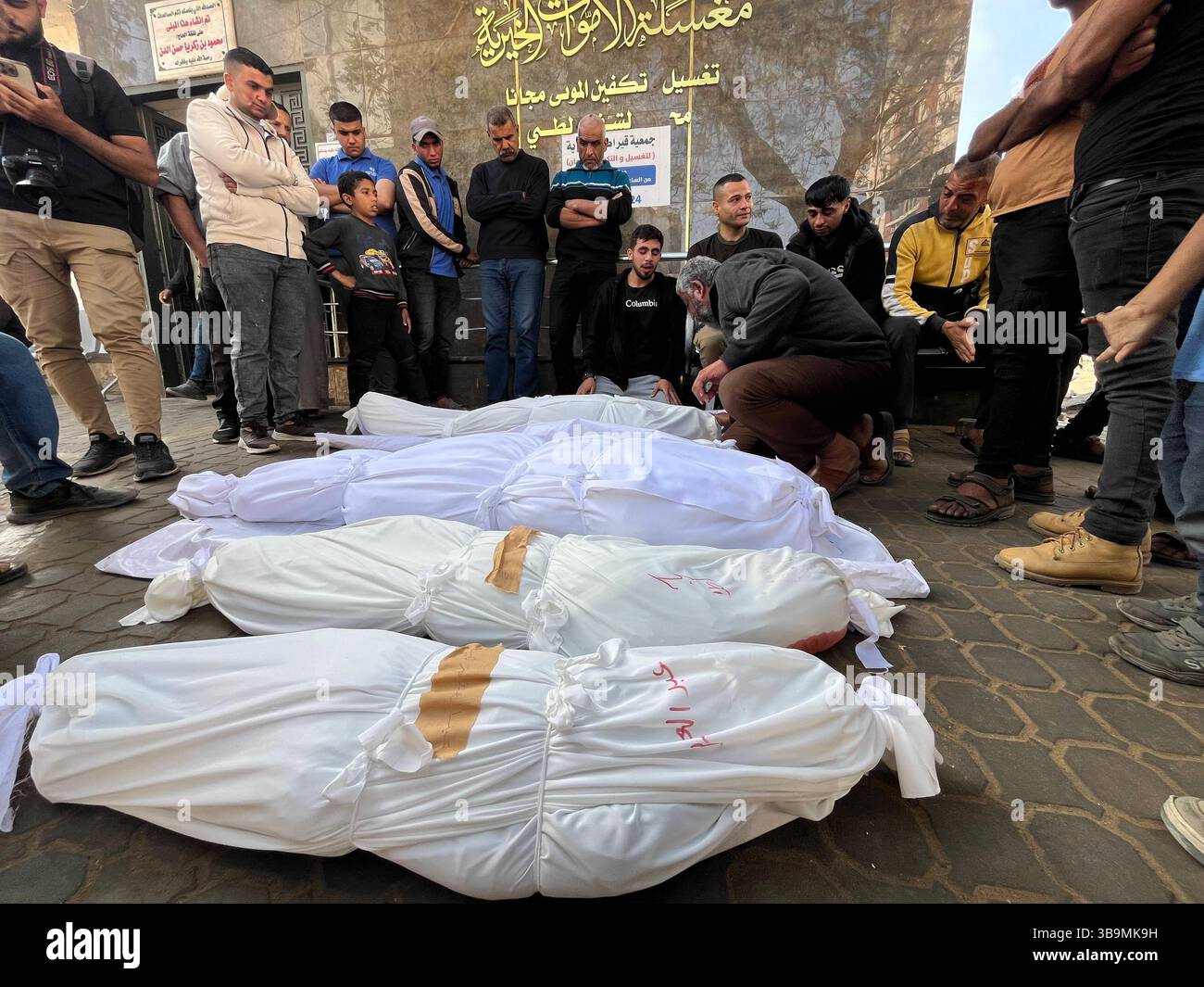 Palestinians mourn the loss of their loved ones killed in an Israeli ...