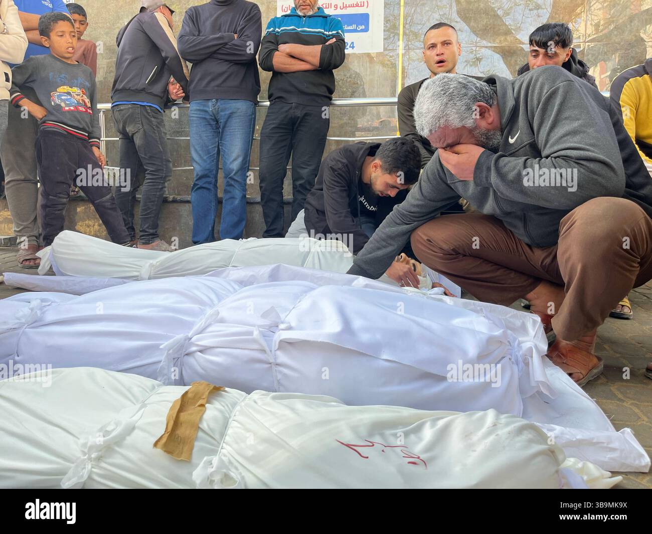 Palestinians mourn the loss of their loved ones killed in an Israeli ...