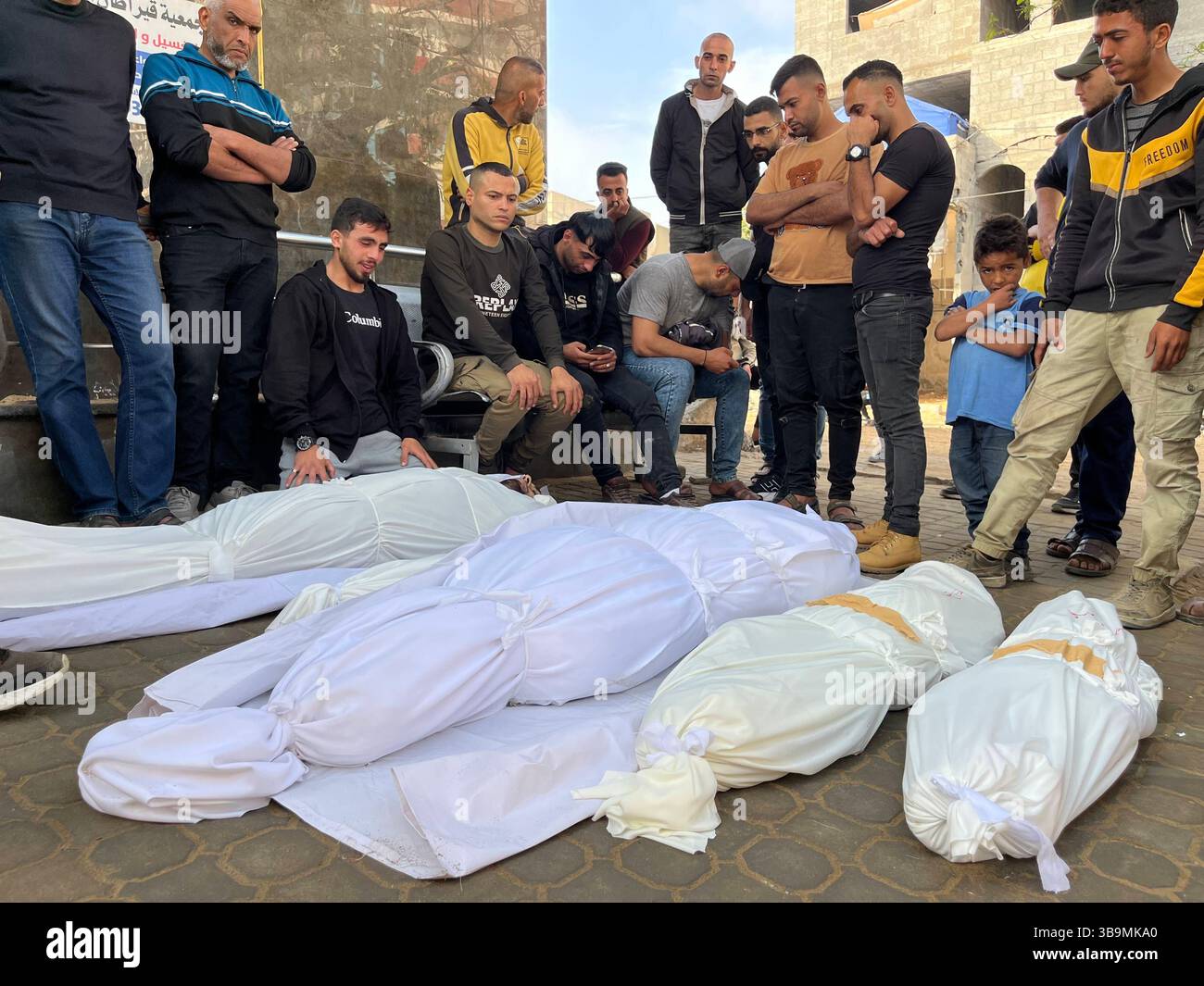 Palestinians mourn the loss of their loved ones killed in an Israeli ...