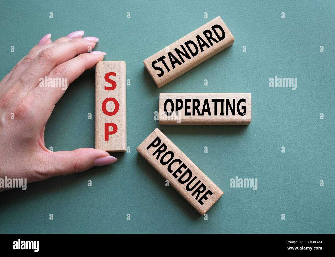 SOP - Standard Operating Procedure symbol. Wooden blocks with word SLA ...