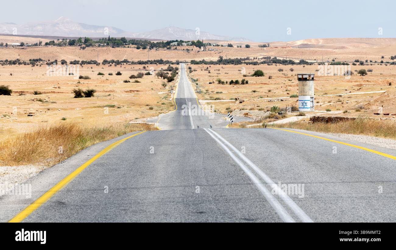 Long, straight highway in the Jordan Valley in Israel with a watchtower ...