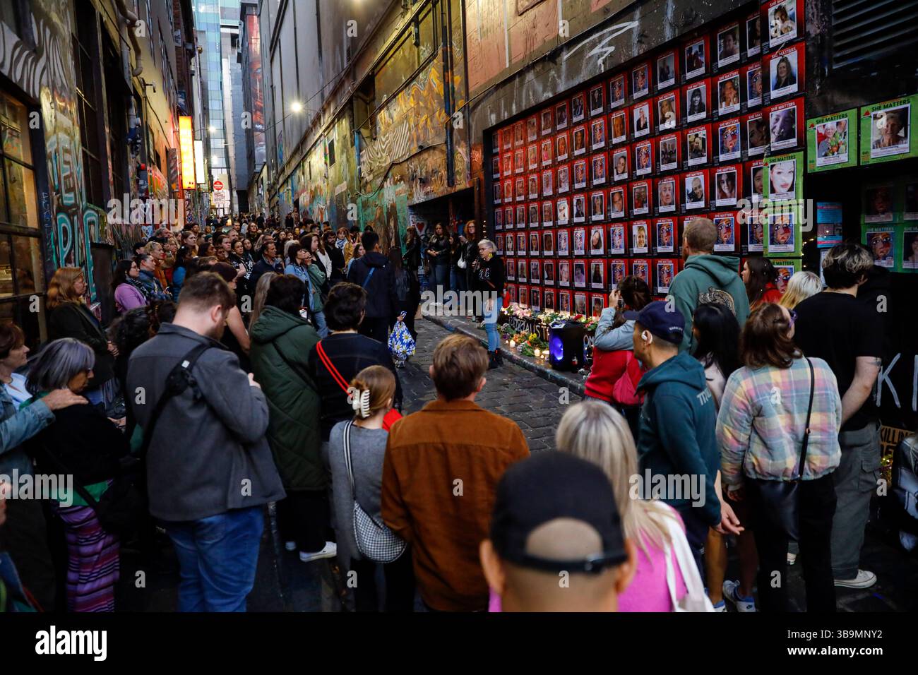 People gather during the Mother's Day Eve memorial vigil at the She Matters Mural in Melbourne ...