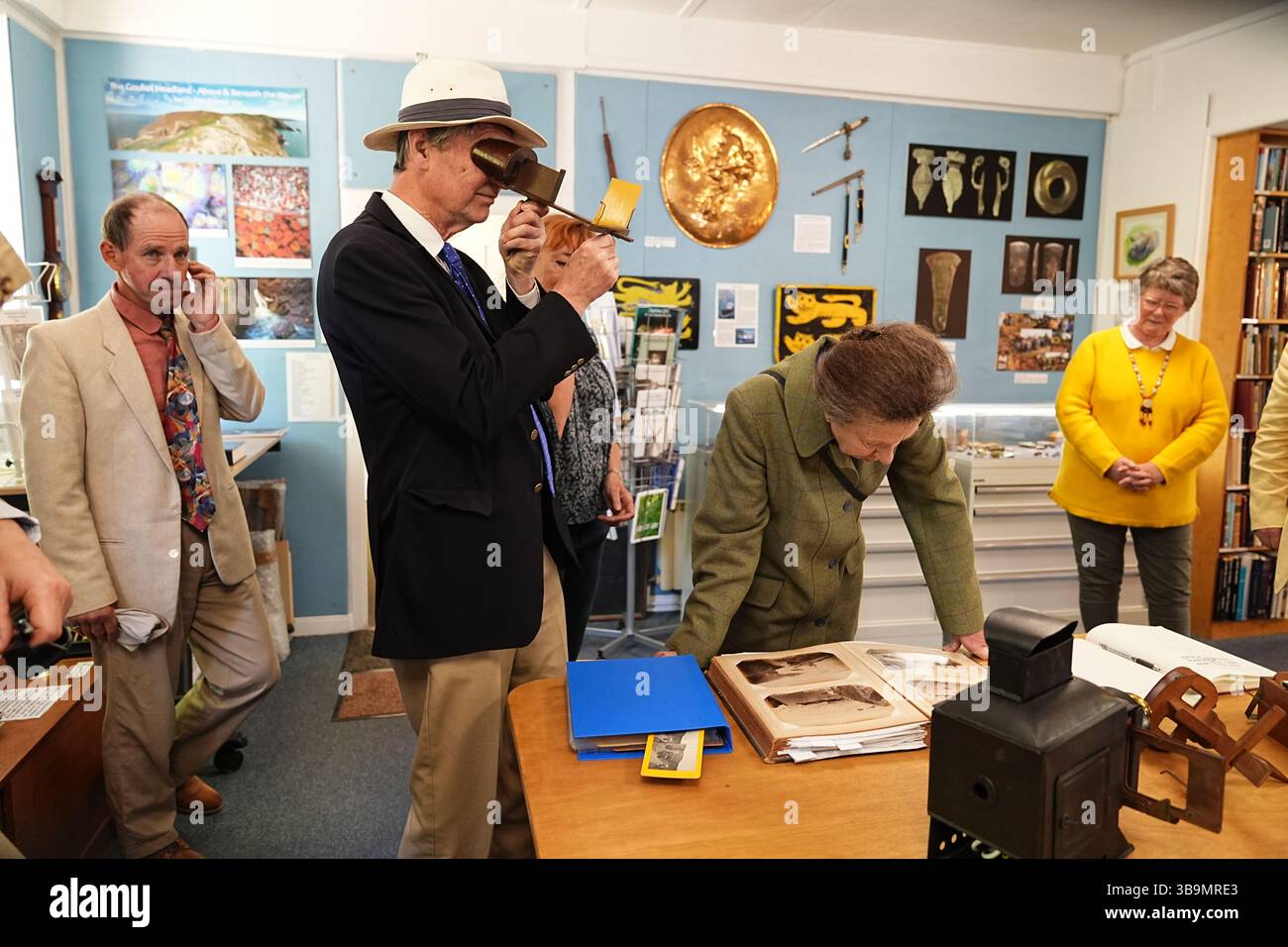 Vice Admiral Sir Tim Laurence looking at photos using a stereoscopic ...