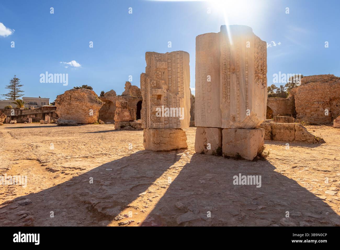 Sunlit ruins and stones with Roman inscriptions throwing shadows, Baths ...