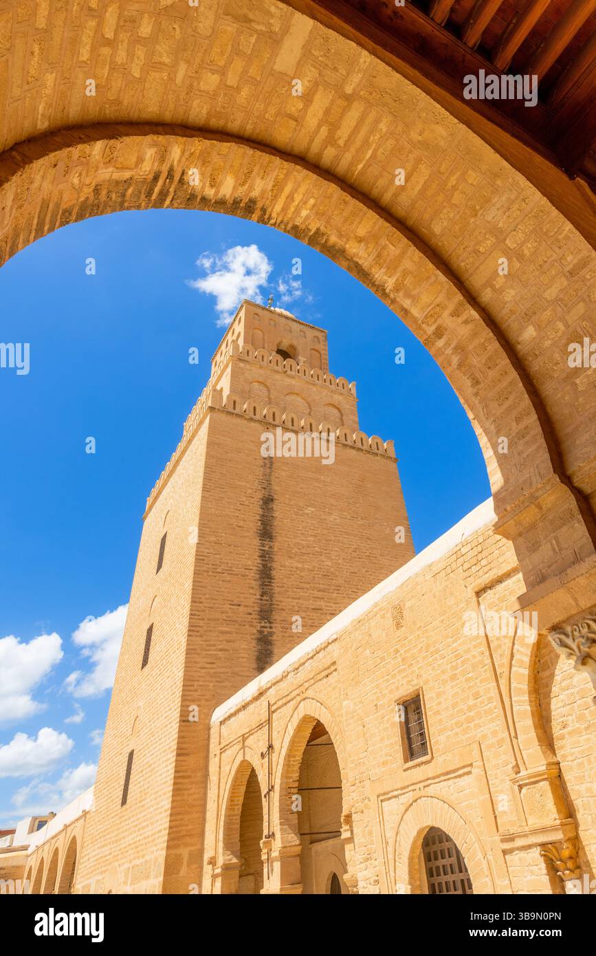 Arch view to minaret tower of the Great Mosque of Uqba with clouds in ...