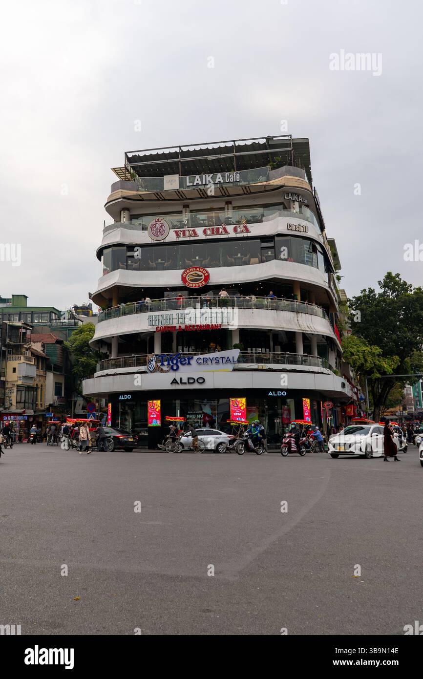 A multi-story building in Vietnam displays various businesses ...