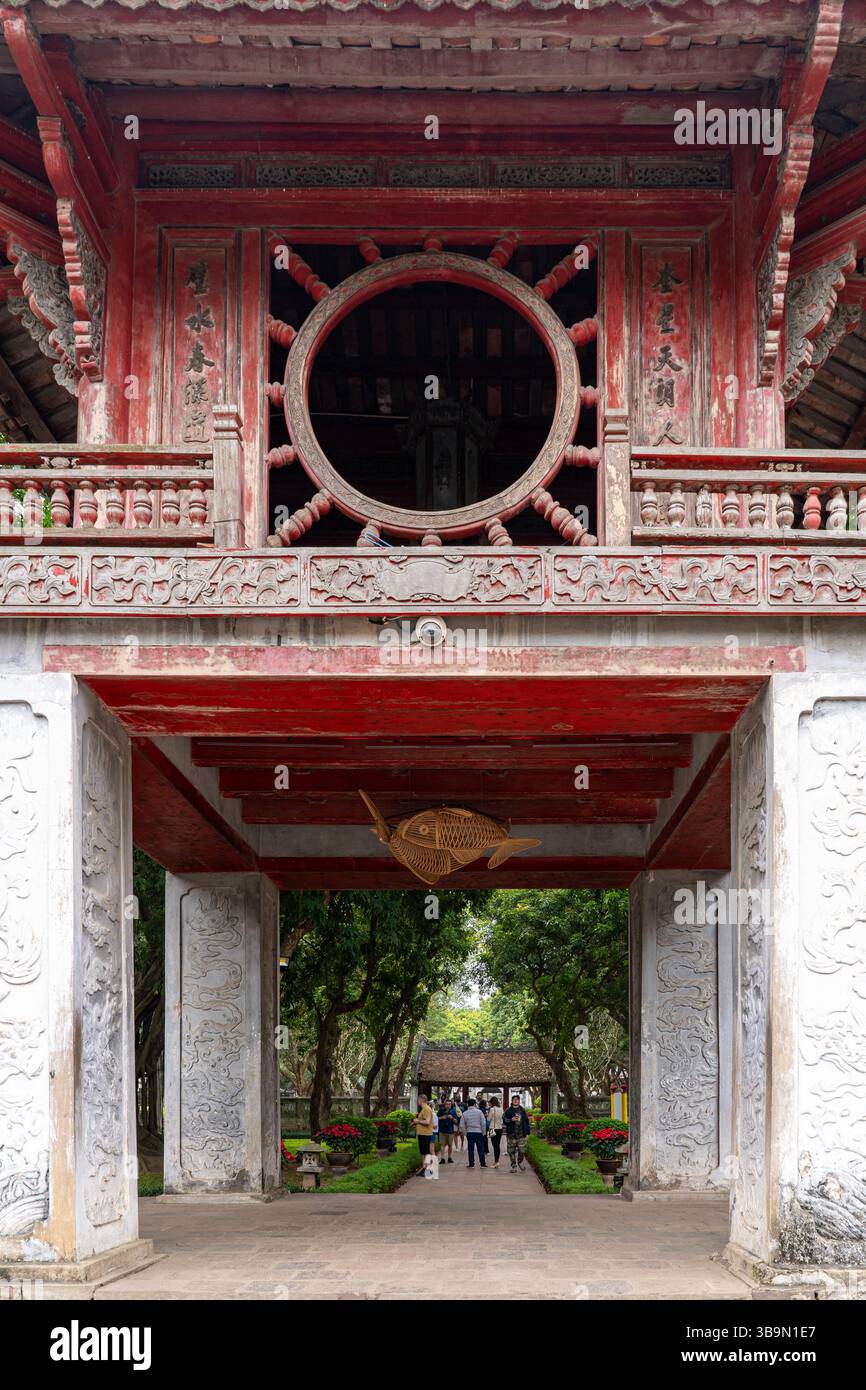 View of a traditional Vietnamese temple entrance, showing intricate carvings and a welcoming ...