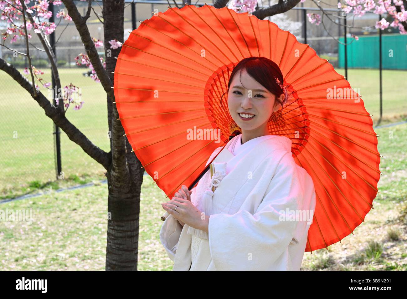 Japanese woman holding a red wagasa umbrella wearing traditional ...