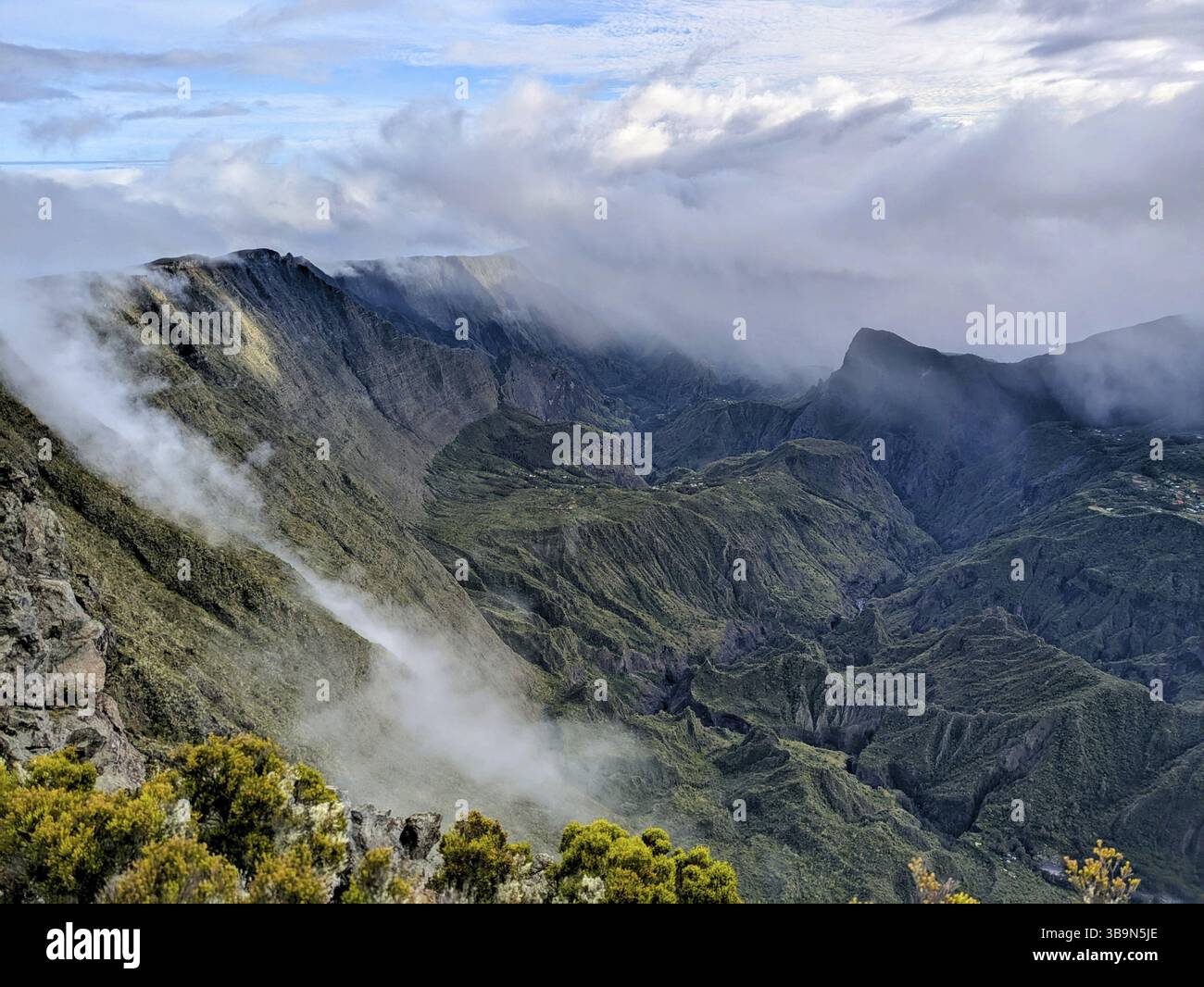 An expansive mountain view with clouds and lush greenery, La Reunion ...